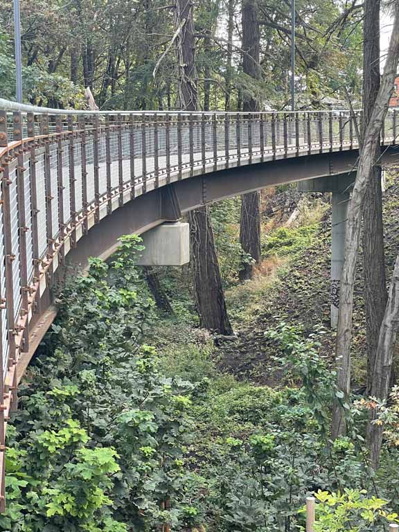 Red Electric Curved Steel Trail Bridge Provides Pedestrians and ...